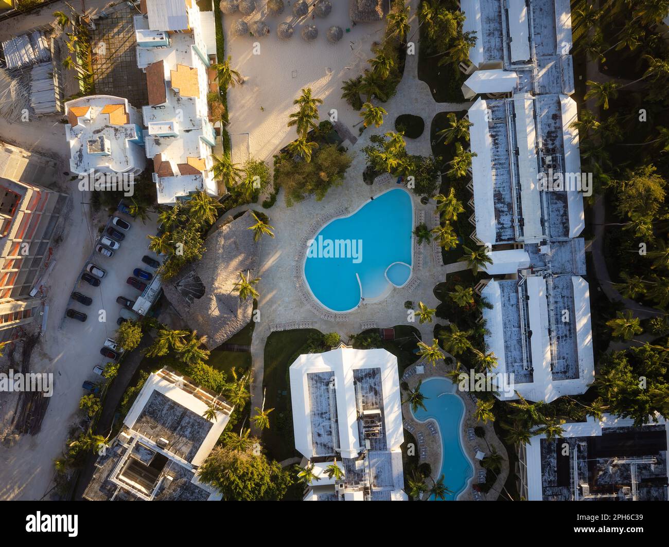 Top view of the resort town with swimming pools, palm trees, tall ...