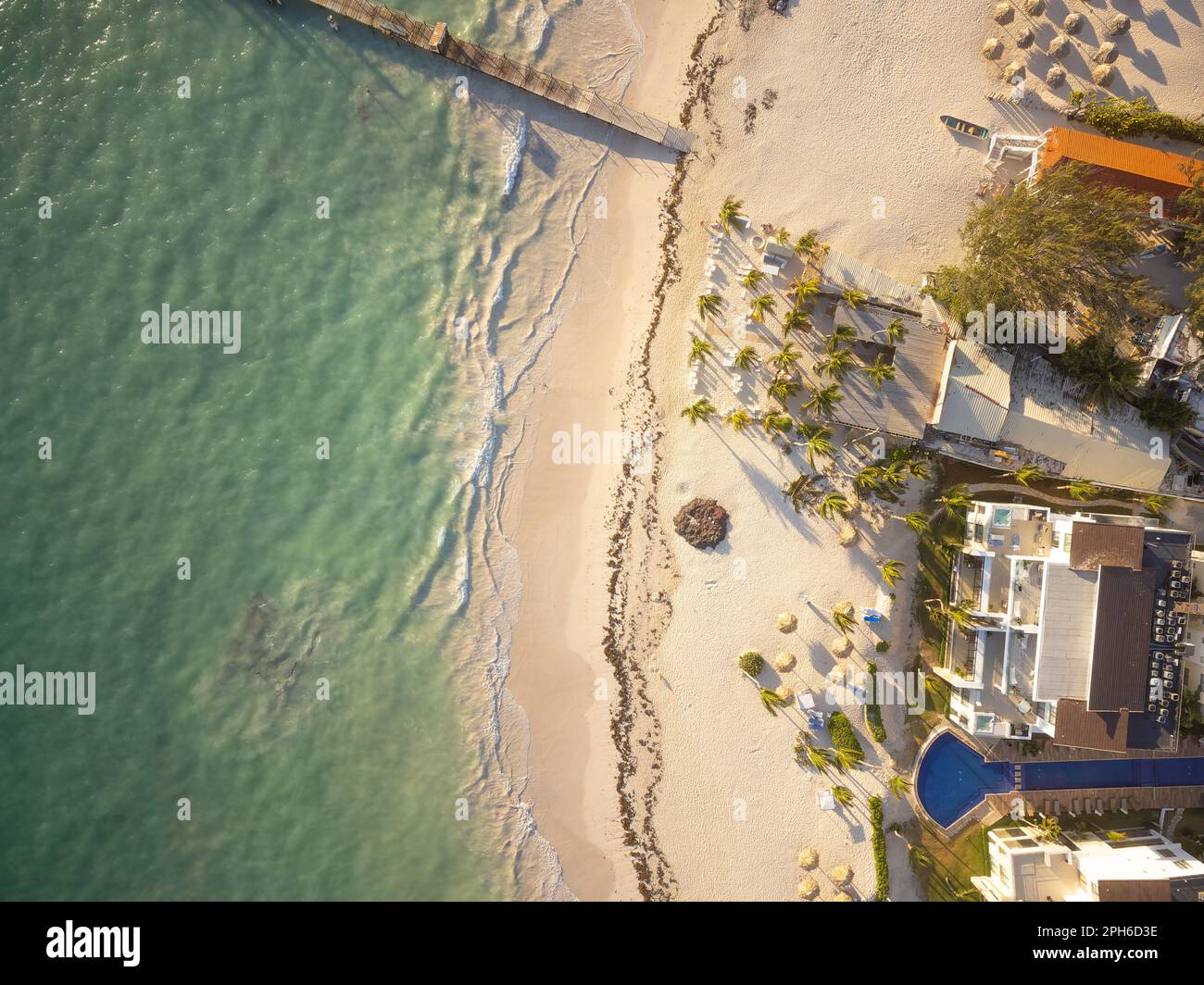 Tropical beach. View from above. Wooden pier in the sea. Hotels ...