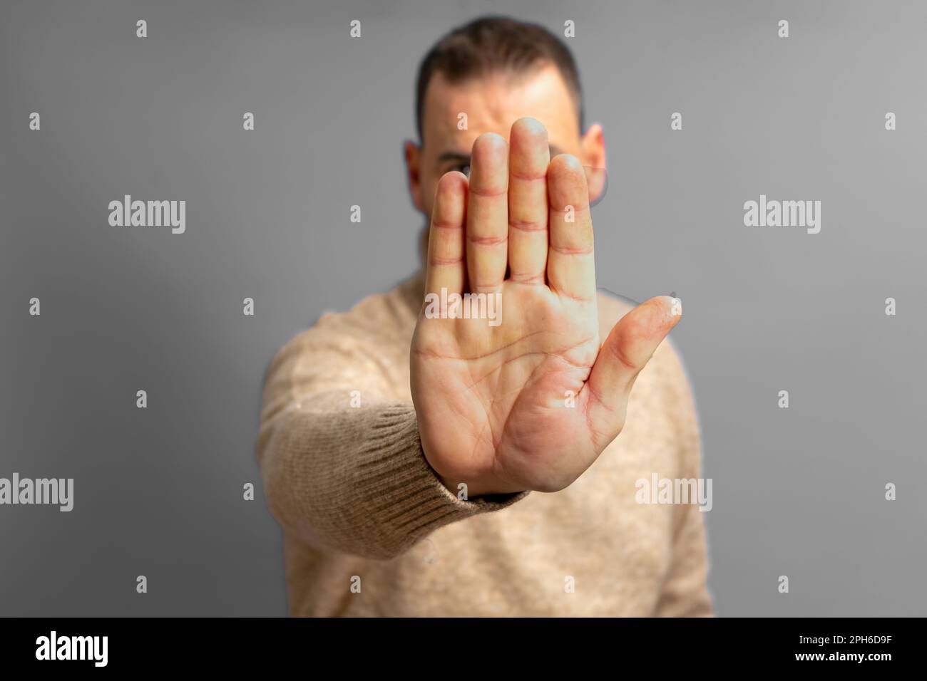 Hispanic man showing hands and palm lines forward with blurred body ...