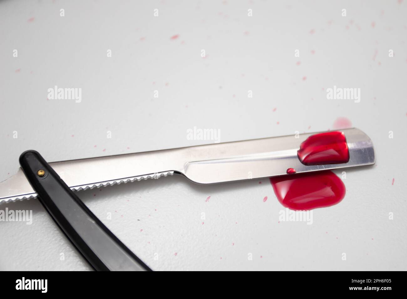 Drops of blood on a straight razor Stock Photo - Alamy