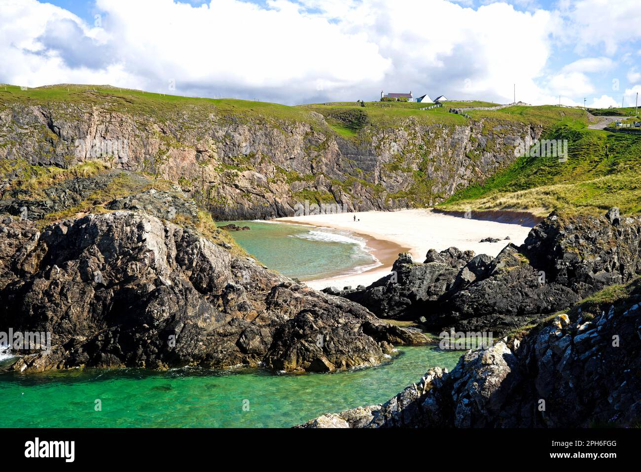 Dramatic rock formations, pristine white sand, and a steep cliff at the ...