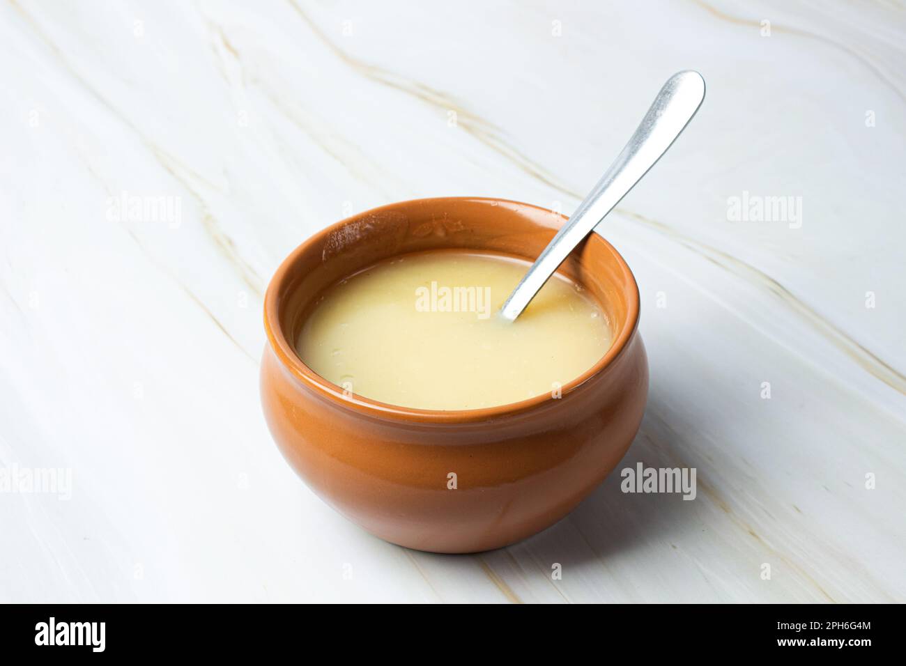 Ghee in traditional pot hi-res stock photography and images - Alamy