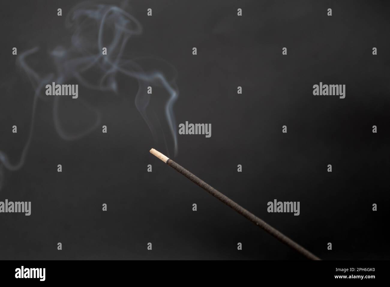 Aromatic smoking stick on a black background Stock Photo - Alamy