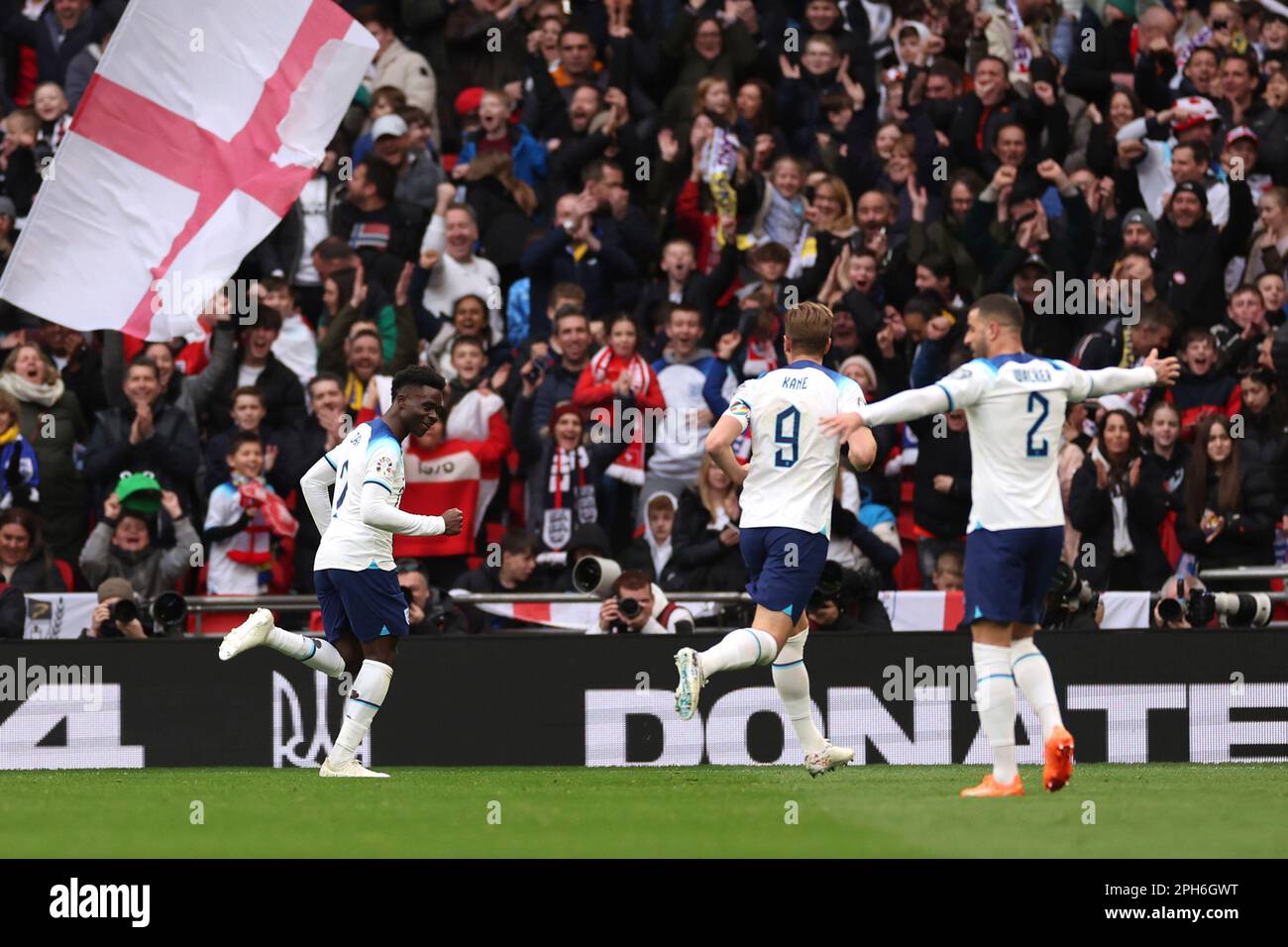 England's Bukayo Saka, left, celebrates after scoring his side's 2nd ...