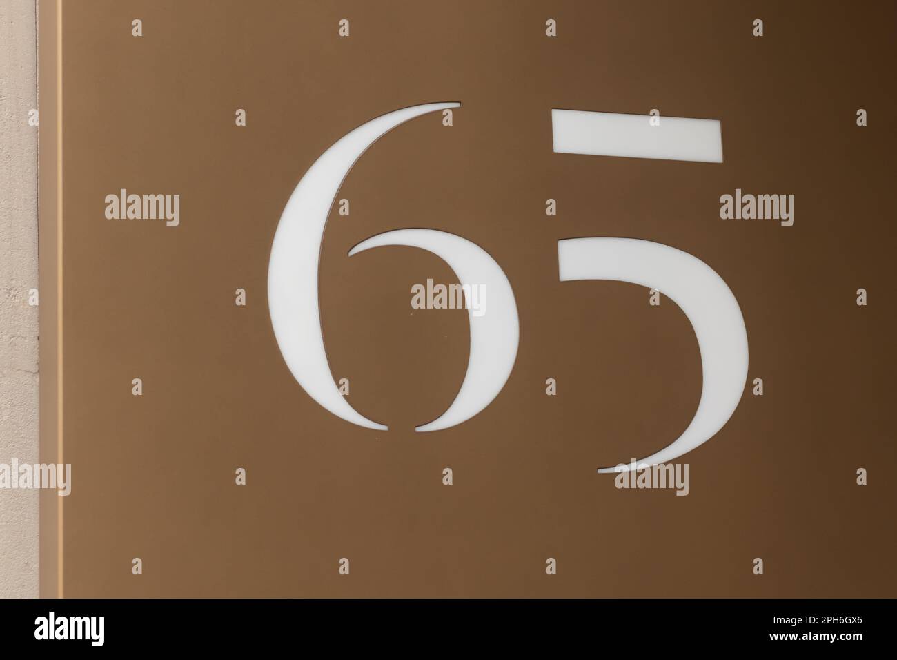 House number 65 as a cut out on a gradient beige background Stock Photo ...