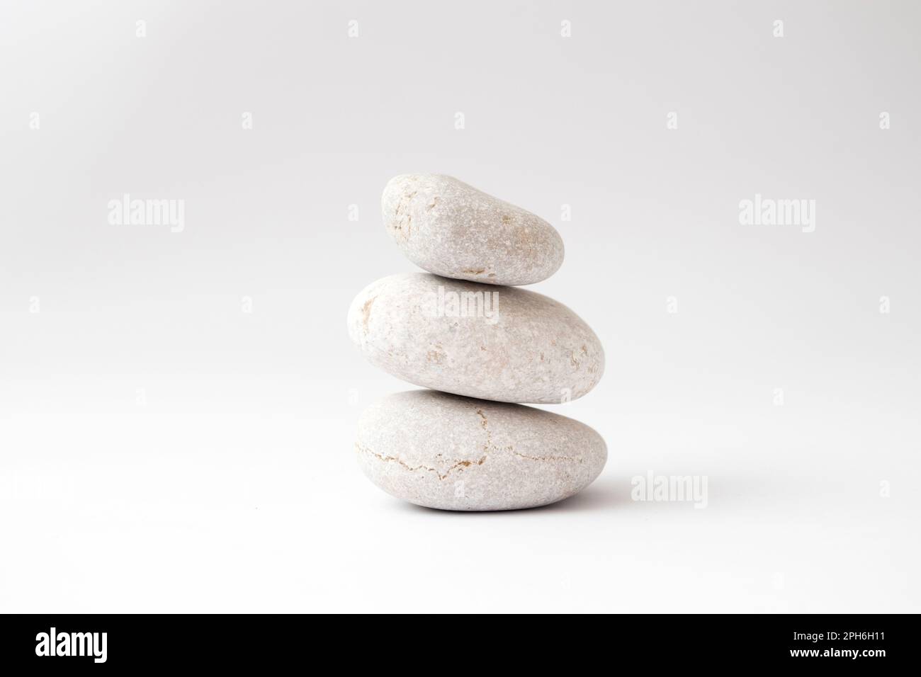 a stack of balancing stones on white background Stock Photo - Alamy