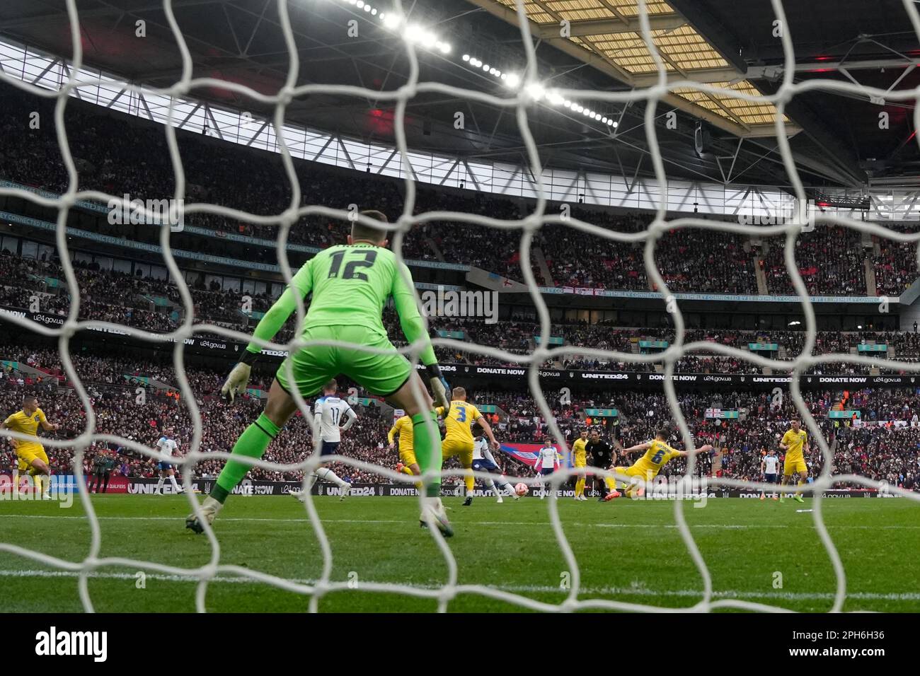 Englands' Bukayo Saka, background centre, scores his side's second goal ...