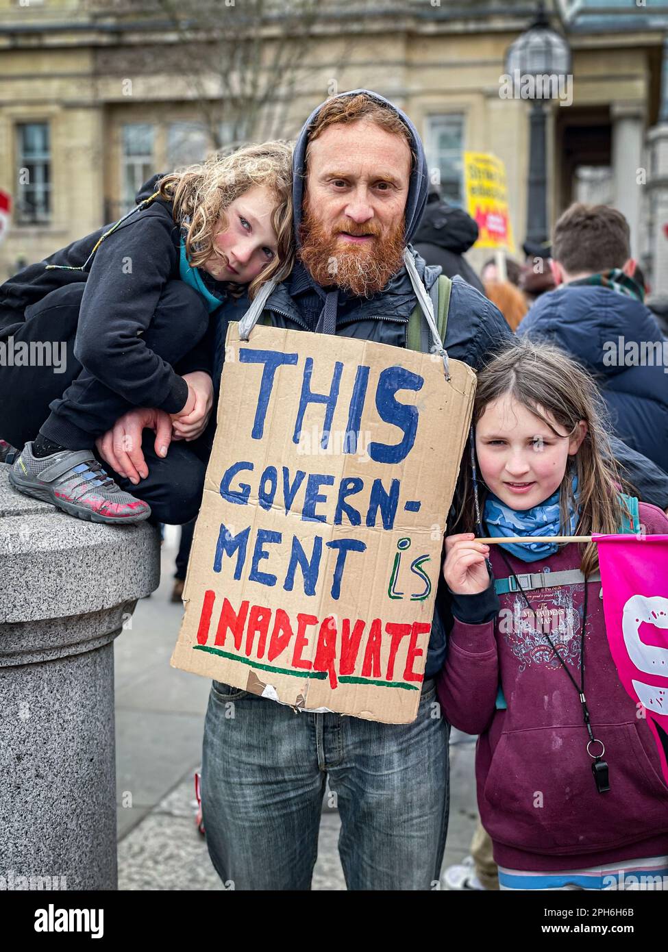 London, UK. 15th March, 2023. Father with his children protesting at ...