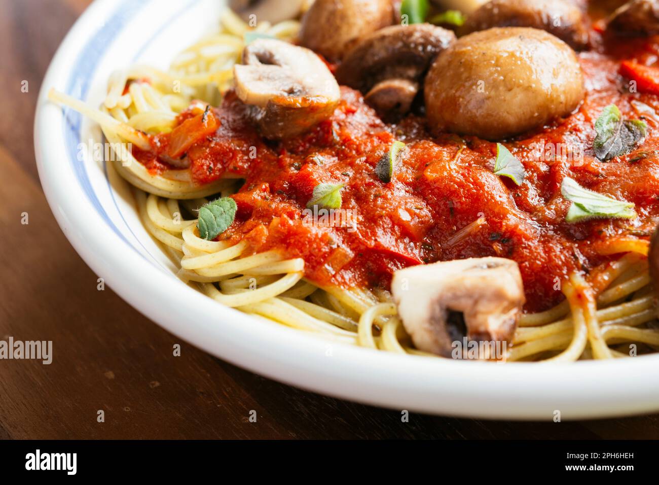 Quinoa spaghetti with mushrooms and a tomato sauce Stock Photo - Alamy