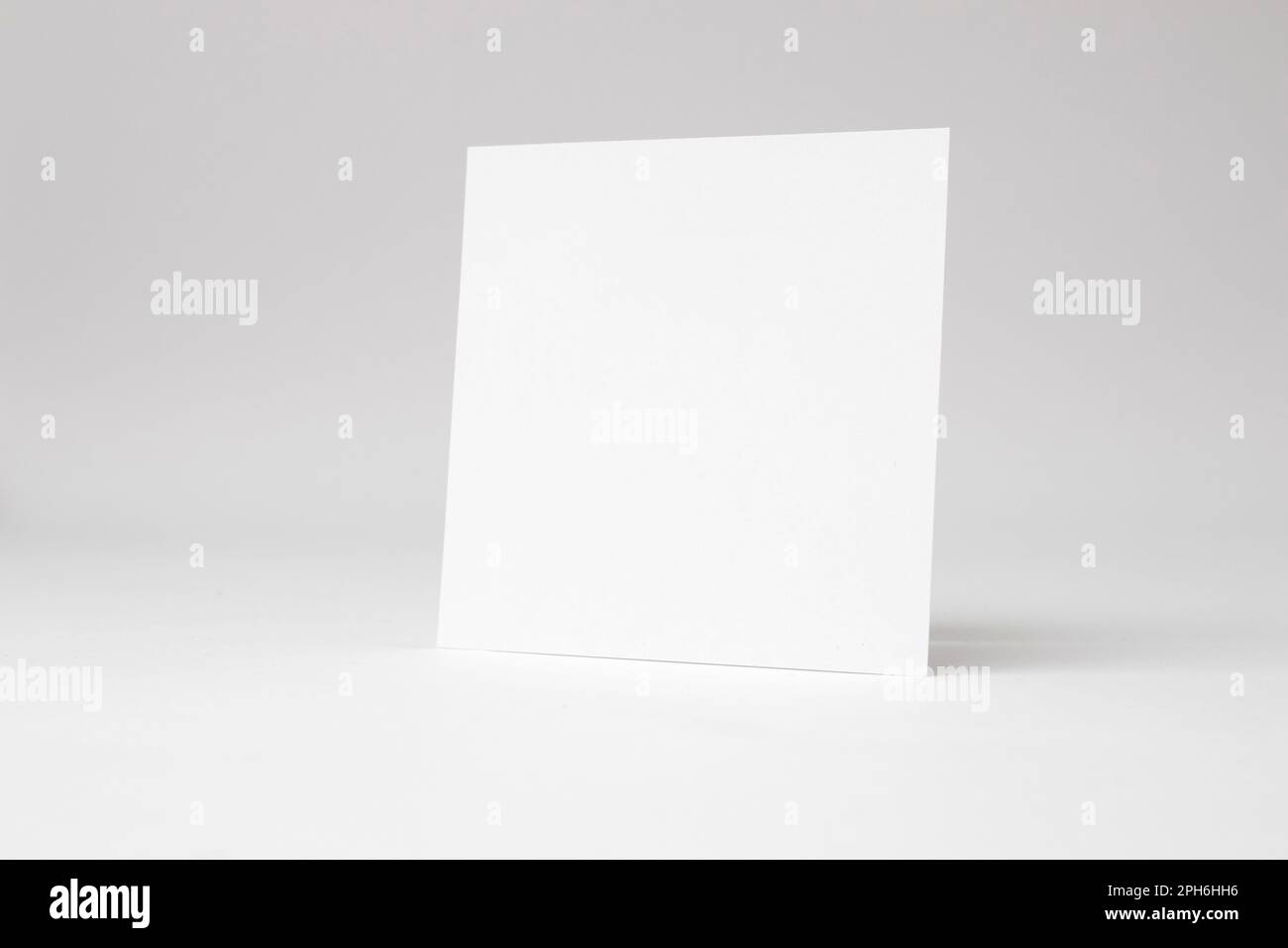A blank square white paper on white background Stock Photo - Alamy