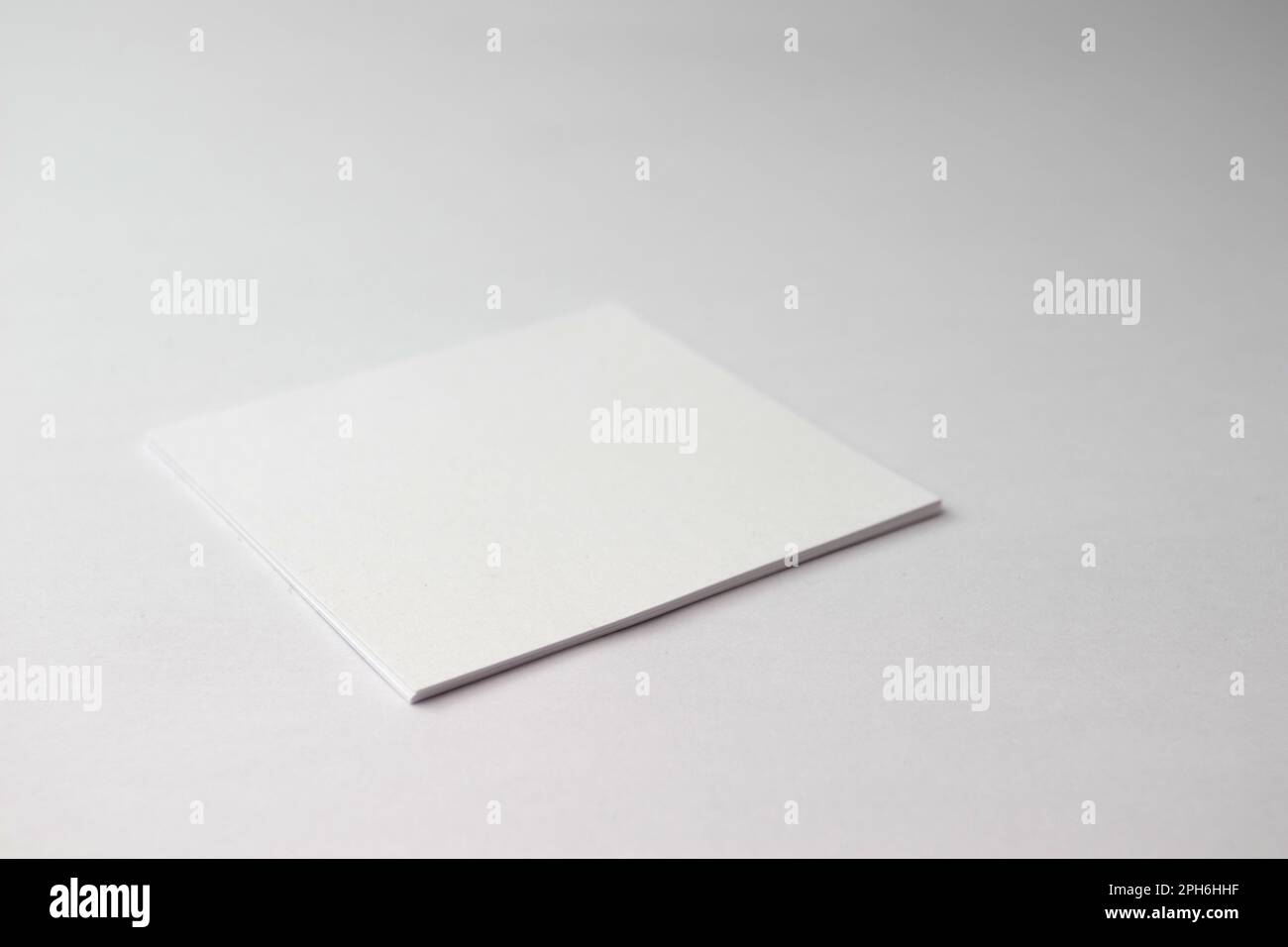 A blank white paper sticker on white background Stock Photo - Alamy