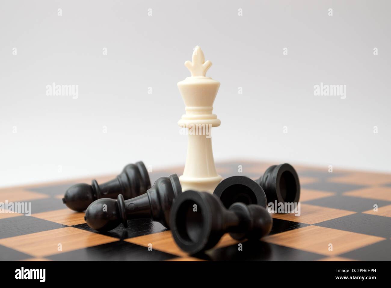 The White Chess queen and fallen black chess pieces Stock Photo - Alamy