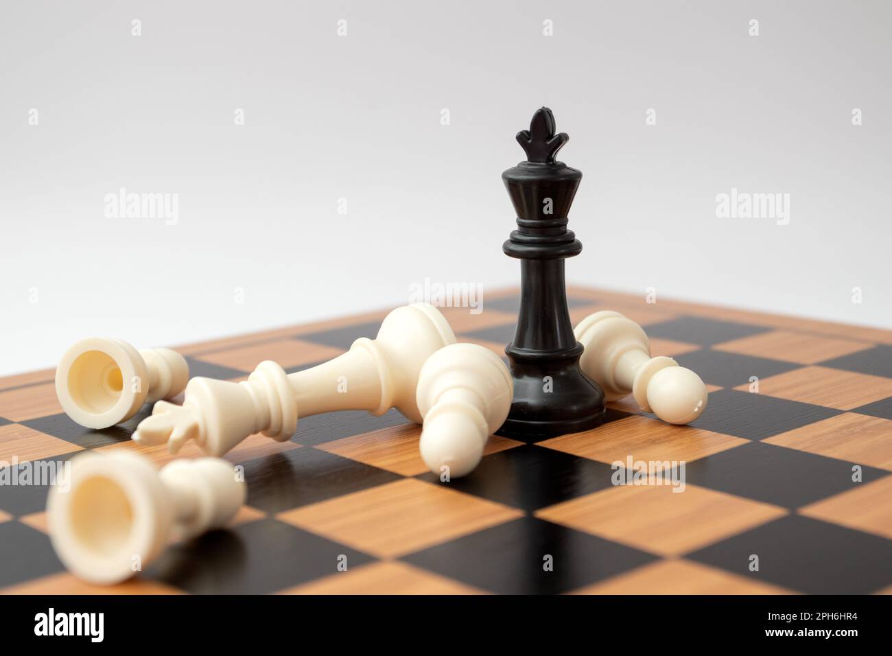 The Black Chess queen and fallen white chess pieces Stock Photo - Alamy