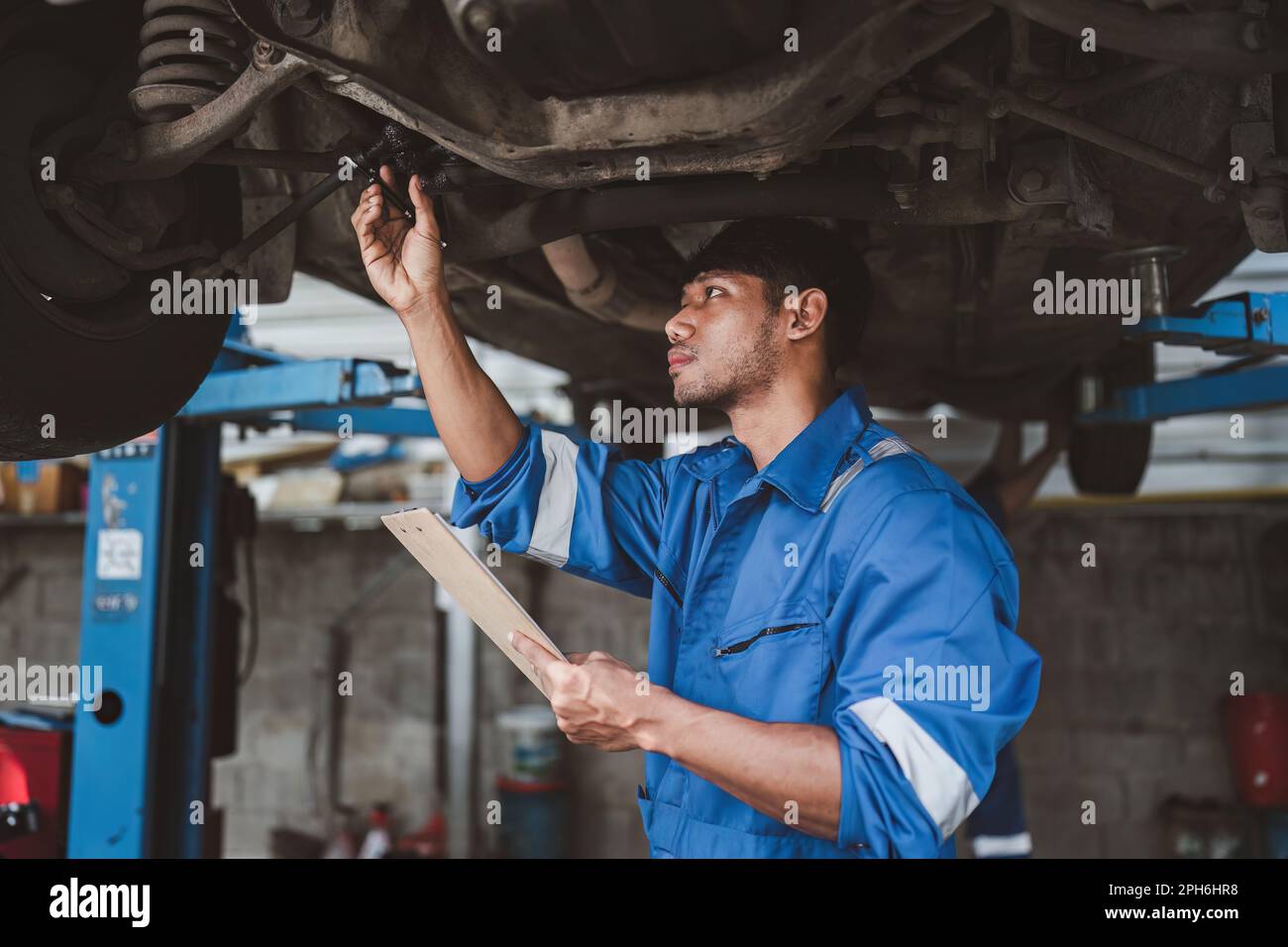 Expert auto mechanic repair and service customer service work on car at ...