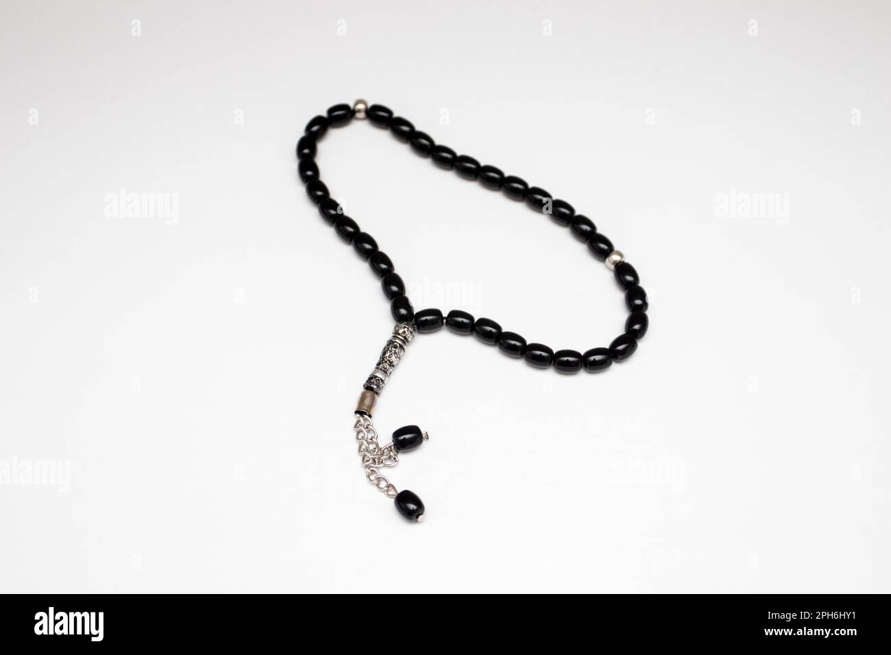 Black Muslim rosary beads on white background Stock Photo - Alamy