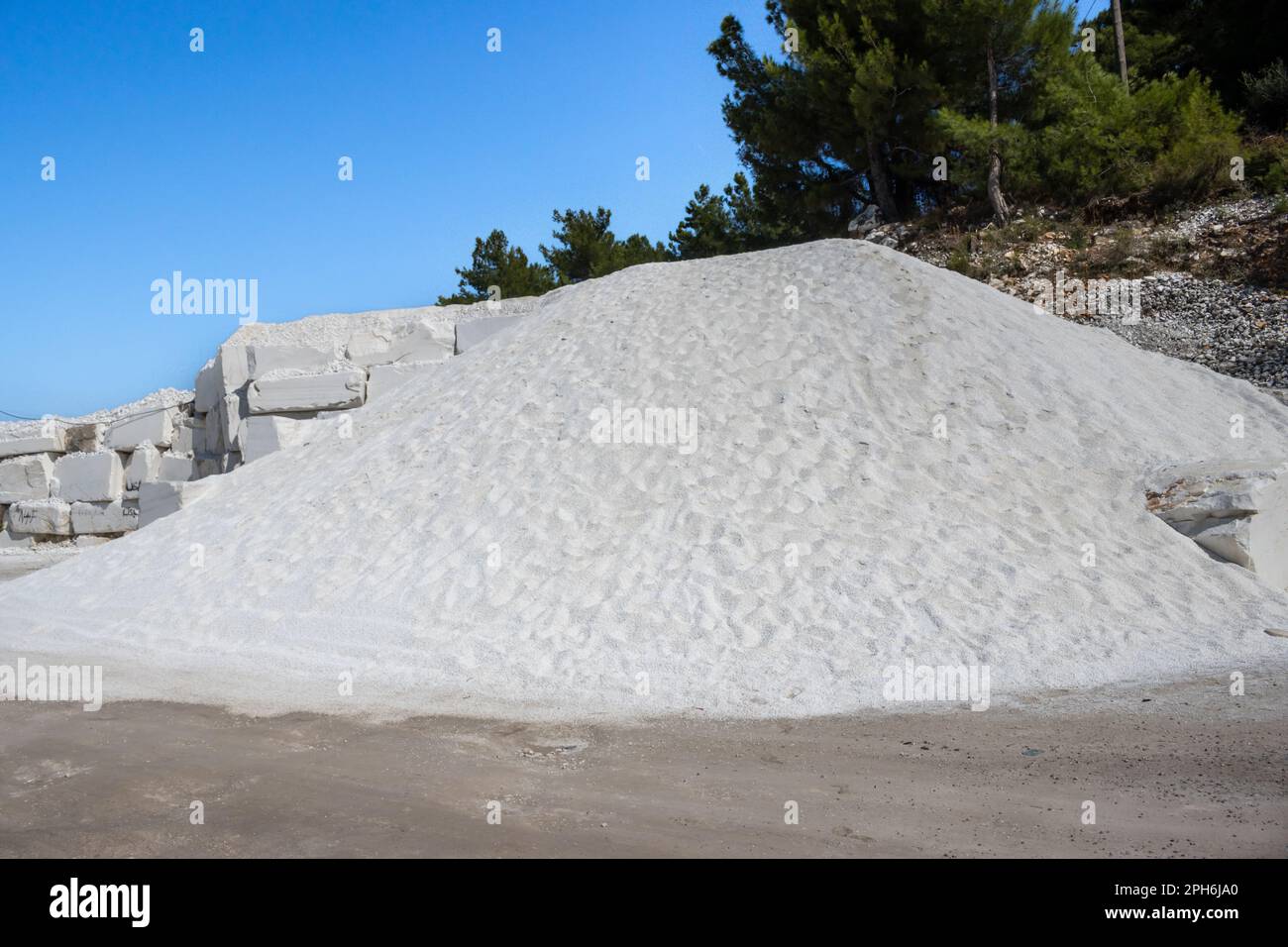 Marble mining at the coast of the island. Bright white marble in blocks ...