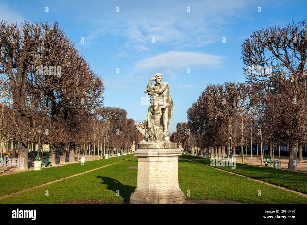 Statue of a standing man resting his arm above the head of a seated ...