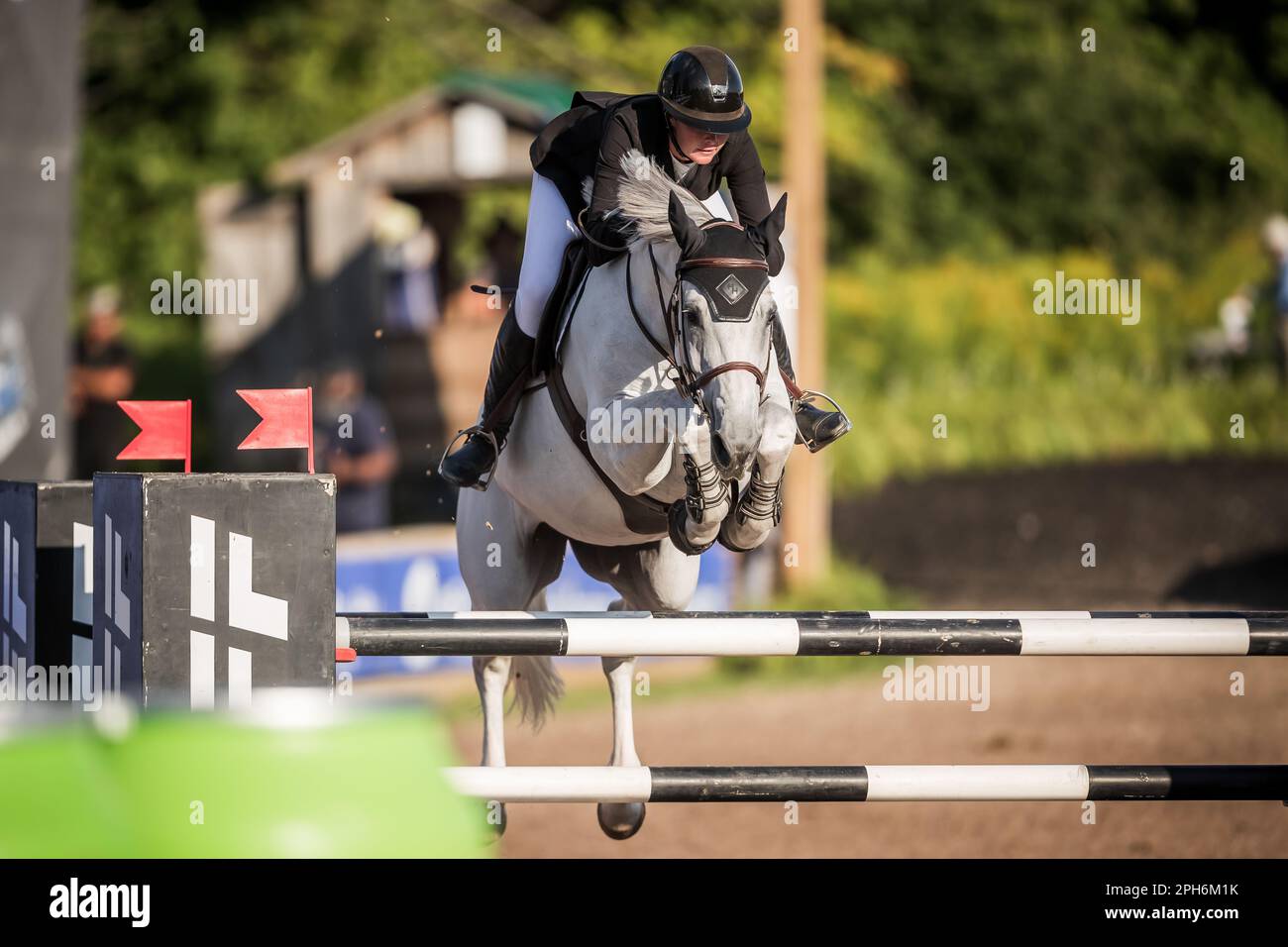 A rider competes in the Major League Show Jumping tour at Angelstone ...