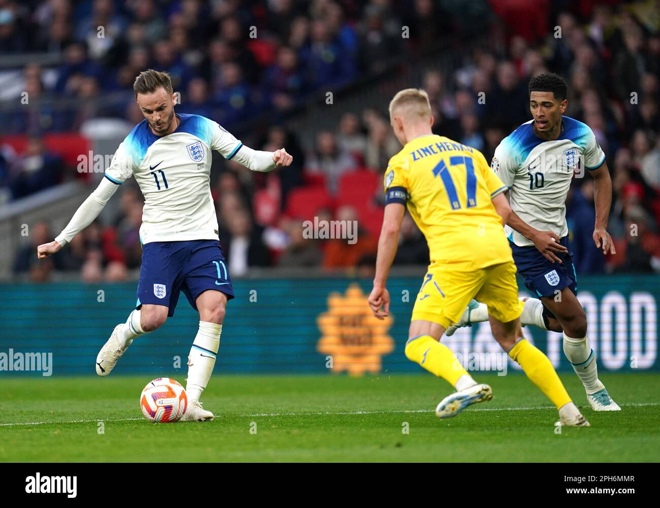 England's James Maddison passes to team-mate Jude Bellingham during the ...