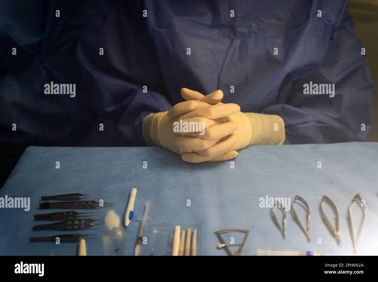 Close-up of the hands of an instrumentalist nurse prepared on a blue ...