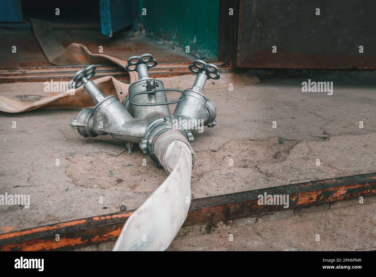metal fire hydrant tee for hoses with taps Stock Photo - Alamy