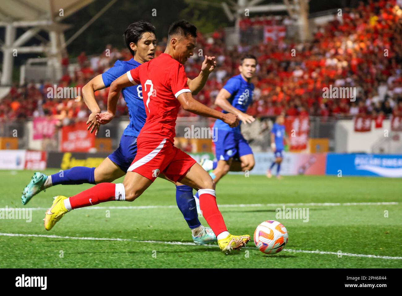 Law Tsz-Chun (7) of Hong Kong vies for the ball with Glenn Kweh Jia Jin ...