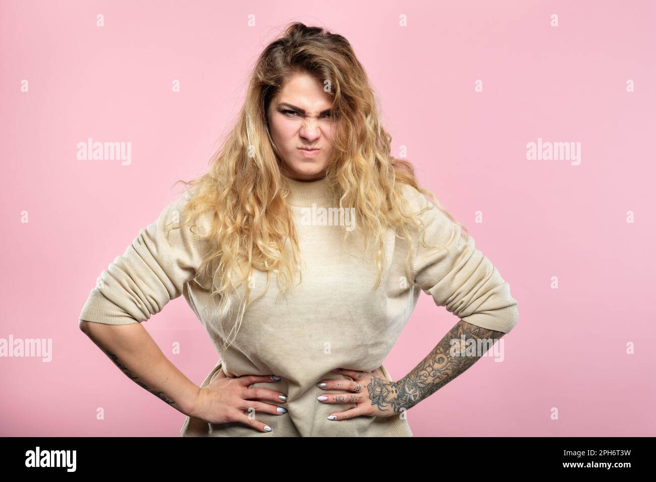 angry cross irritated woman hands hips emotion Stock Photo - Alamy