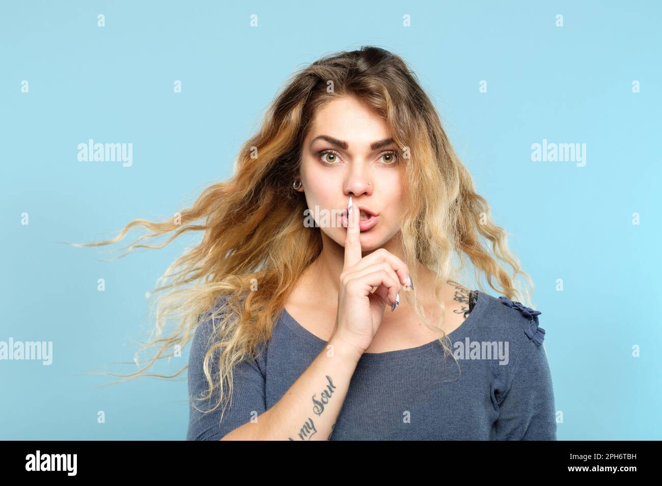 girl keep secret mystery finger on lips Stock Photo - Alamy