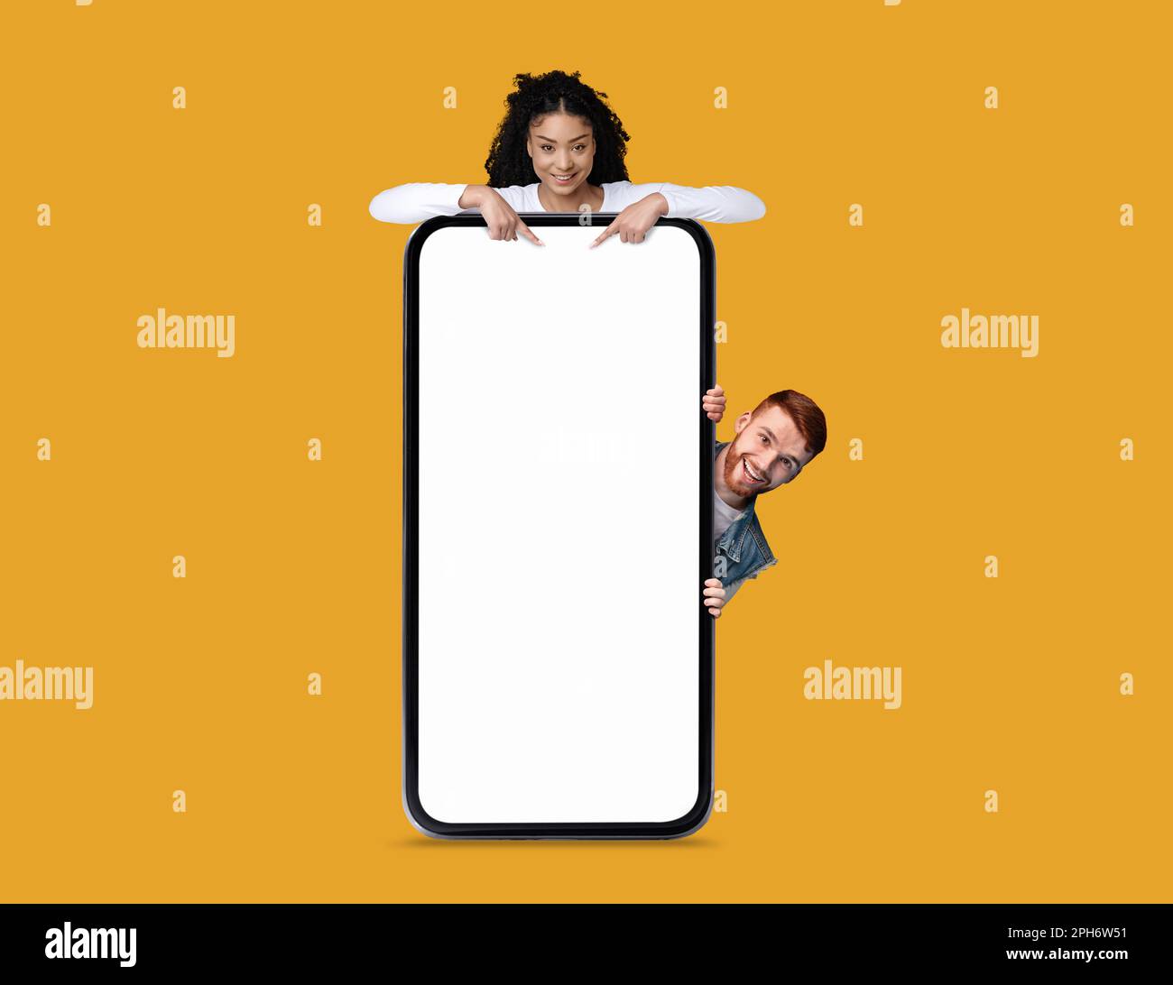 Online Ad. Cheerful Redhead Man And Black Woman Peeking Behind Blank ...