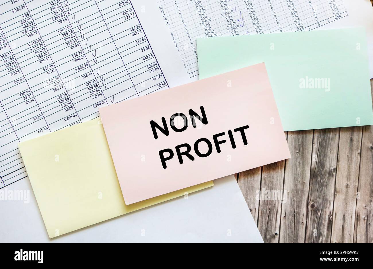 Office table with paper sheet with numbers and stickers. Top text NON ...