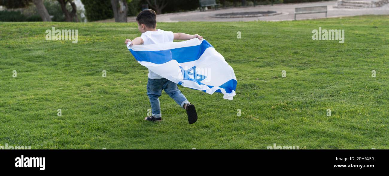 Young child running with Israeli flag. Rear view little boy running ...
