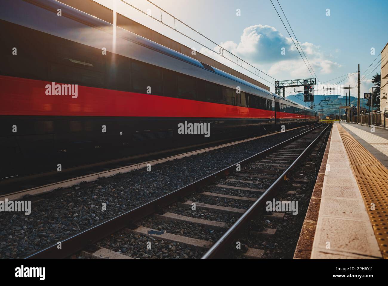 Long train arrives at rural train station in Italy Stock Photo - Alamy