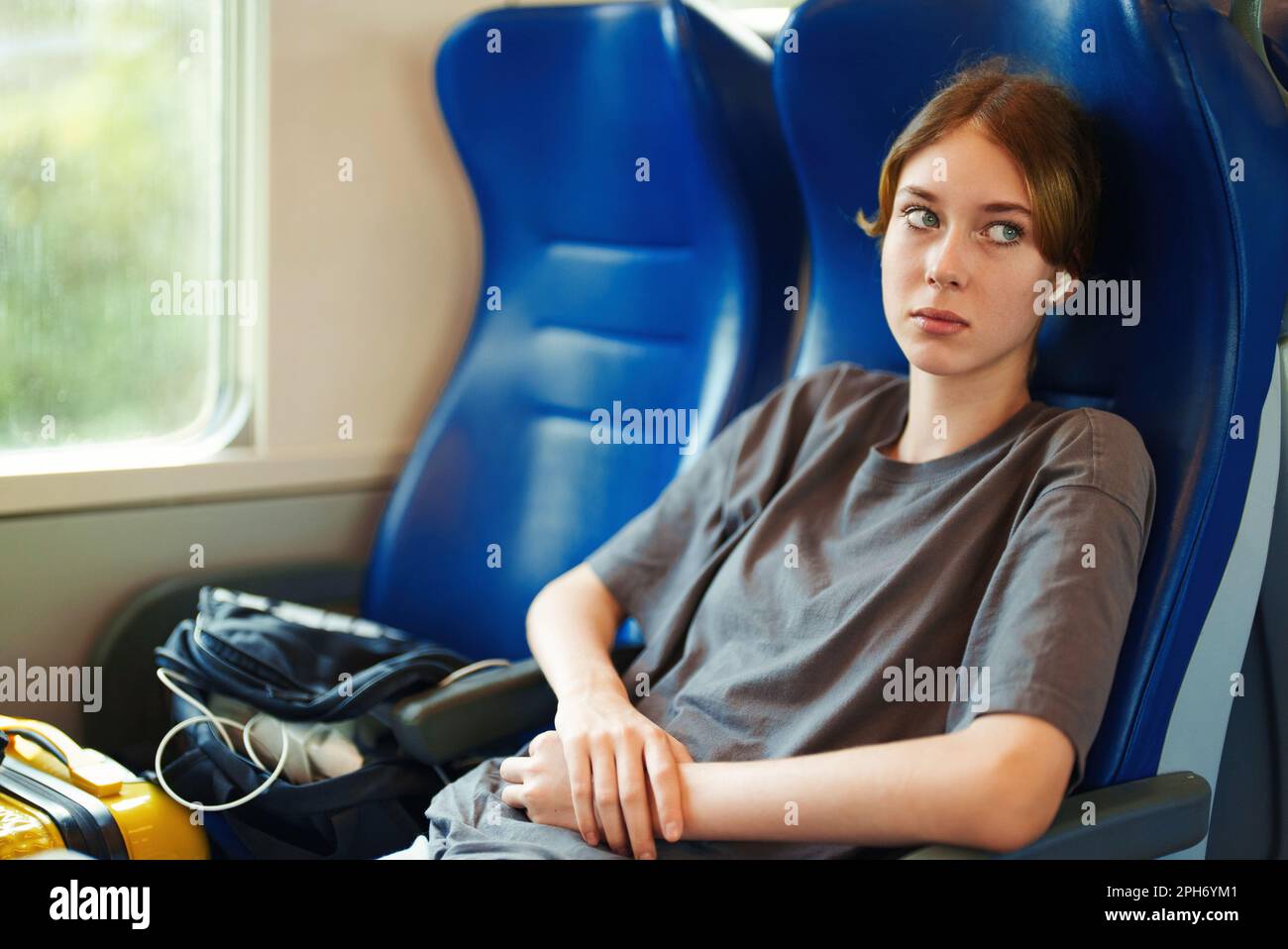 Teenage girl with earphones travelling inside the train Stock Photo - Alamy