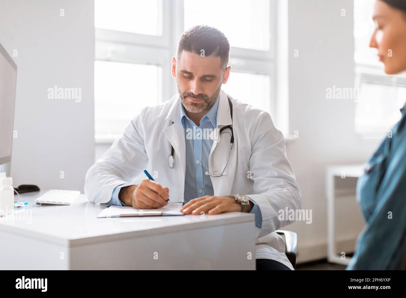 Healthcare, medical check up. Lady visiting doctor, man writing ...