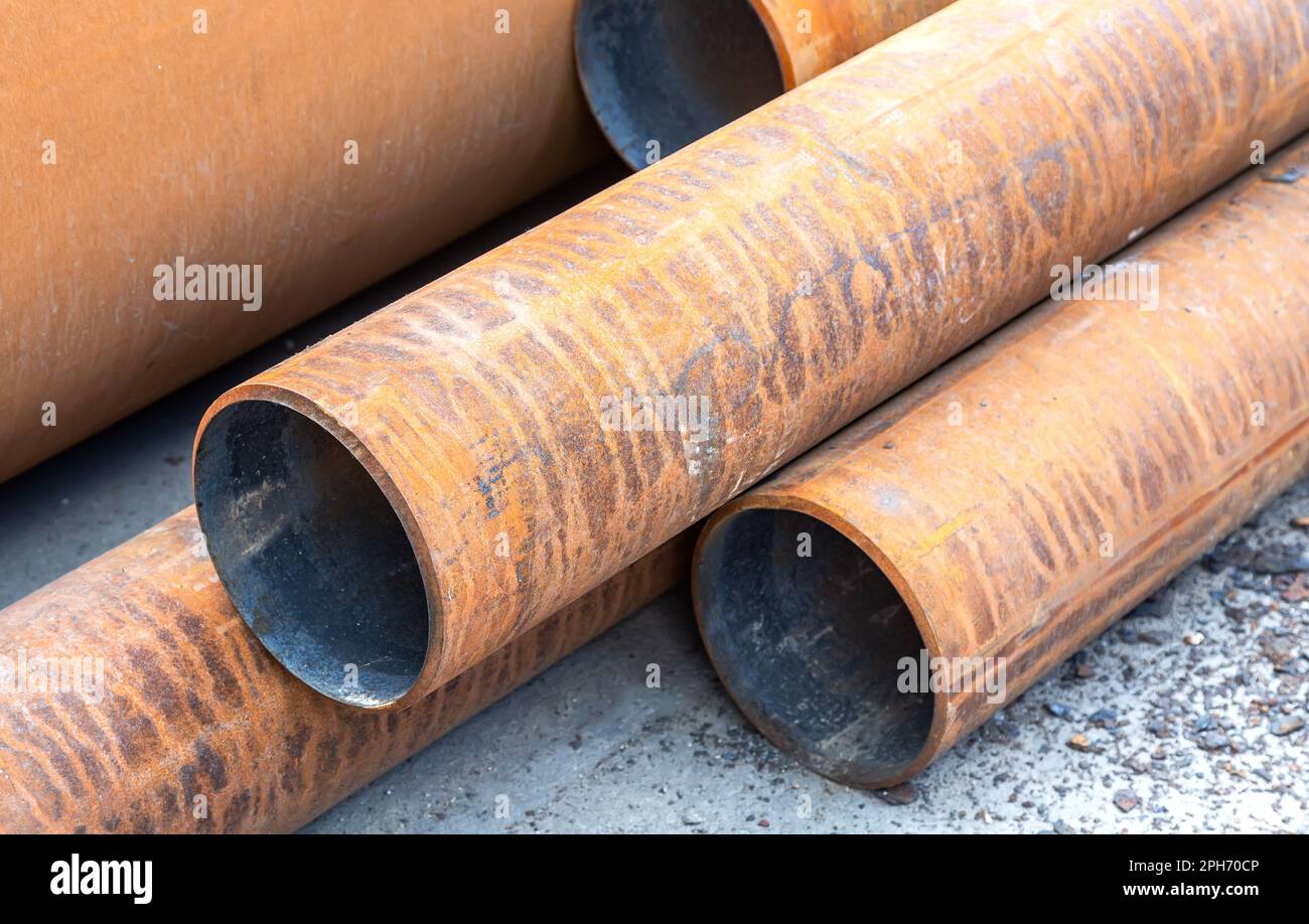 Metal pipes covered with rust at the construction site. Construction ...