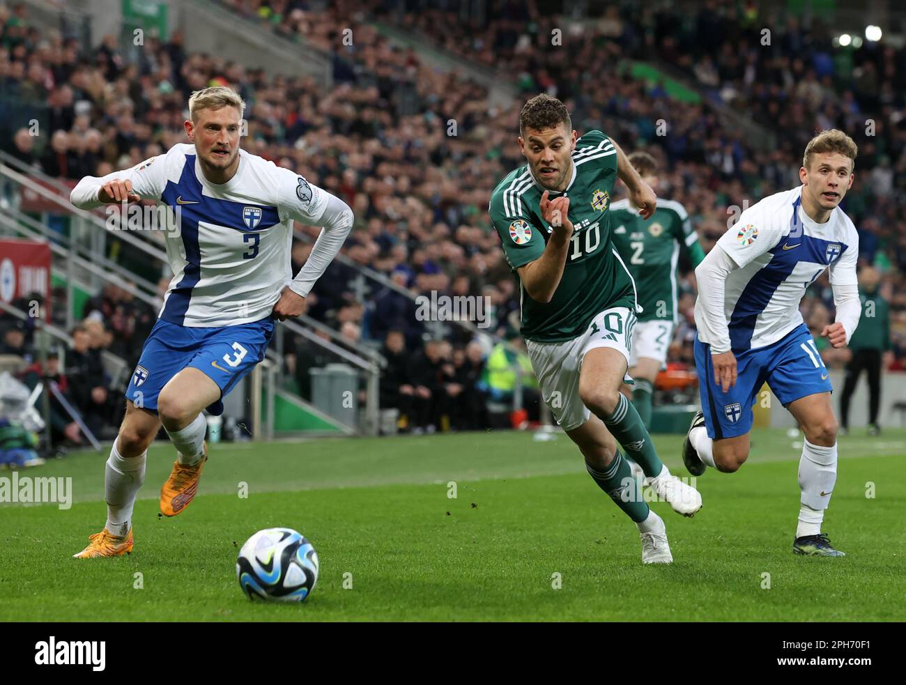 Finland's Richard Jensen and Northern Ireland's Dion Charles battle for ...