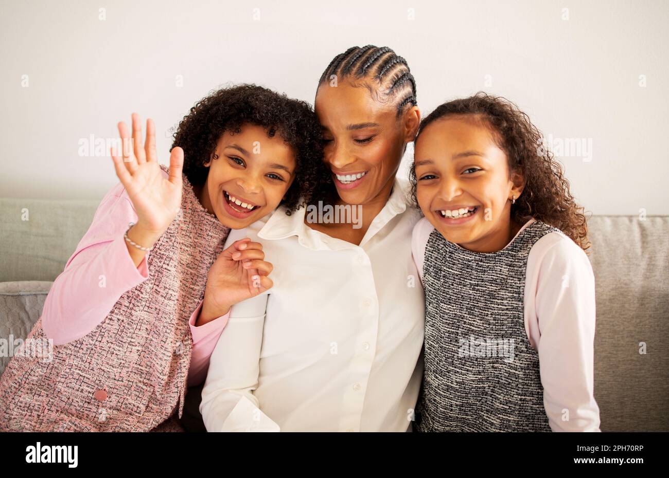 African American Mom And Two Daughters Gesturing Hello At Home Stock Photo - Alamy