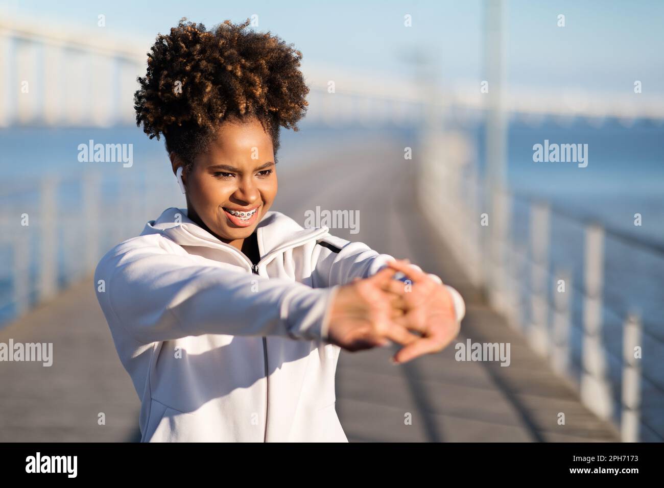 Fit model stretching arms smiling hi-res stock photography and images ...