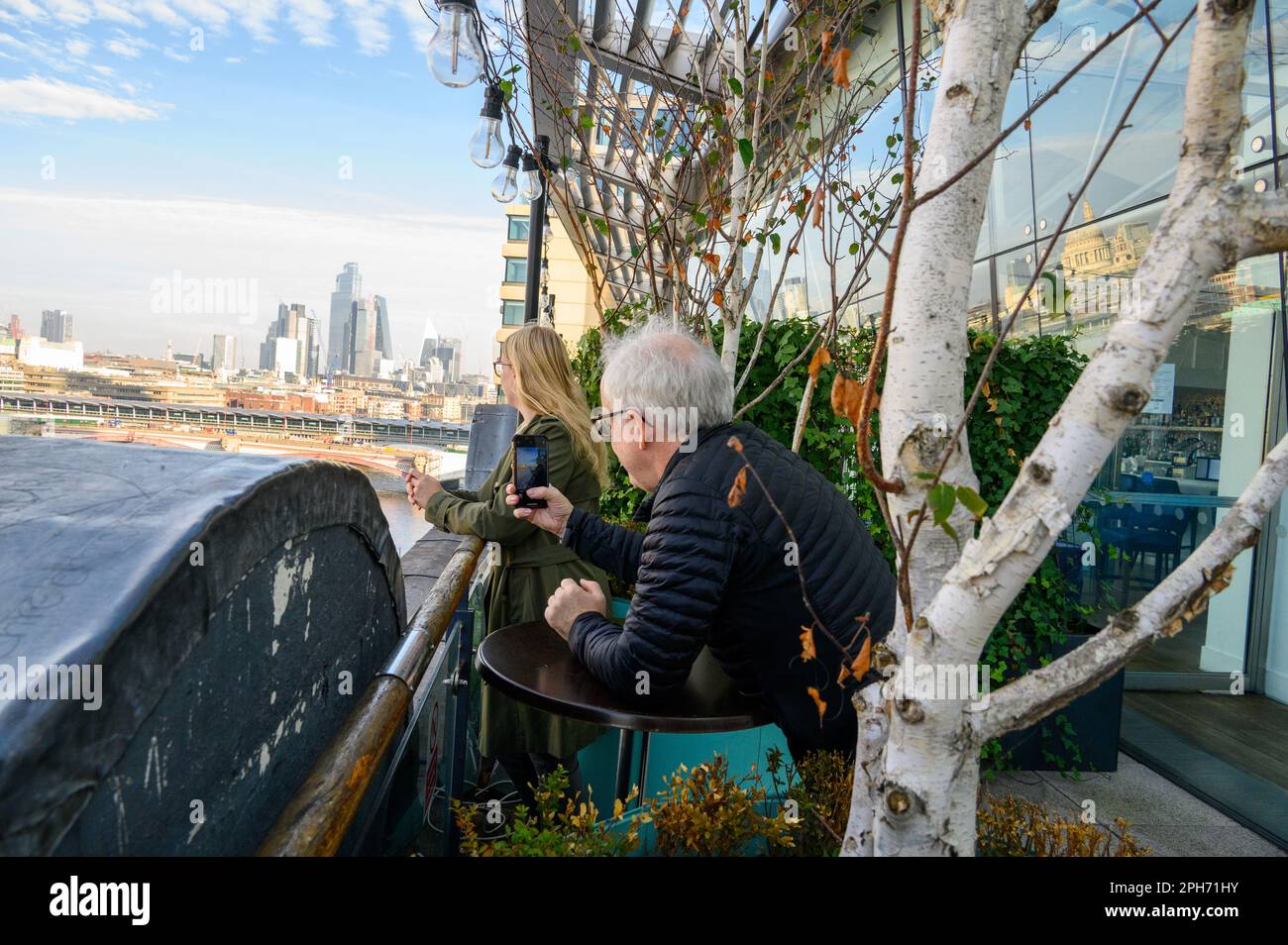 A man captures a precious moment as a woman takes in the breathtaking ...
