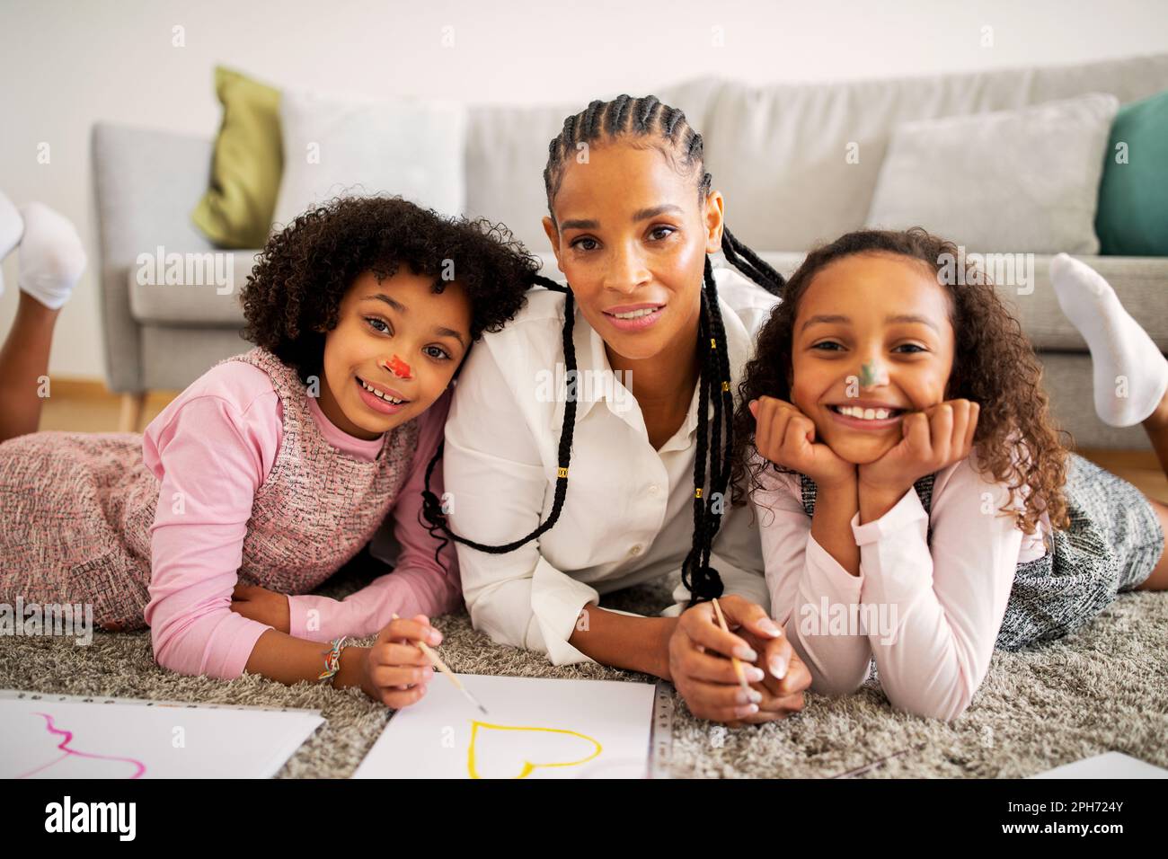 Black Mother Of Two Daughters Drawing With Kids Posing Indoors Stock ...