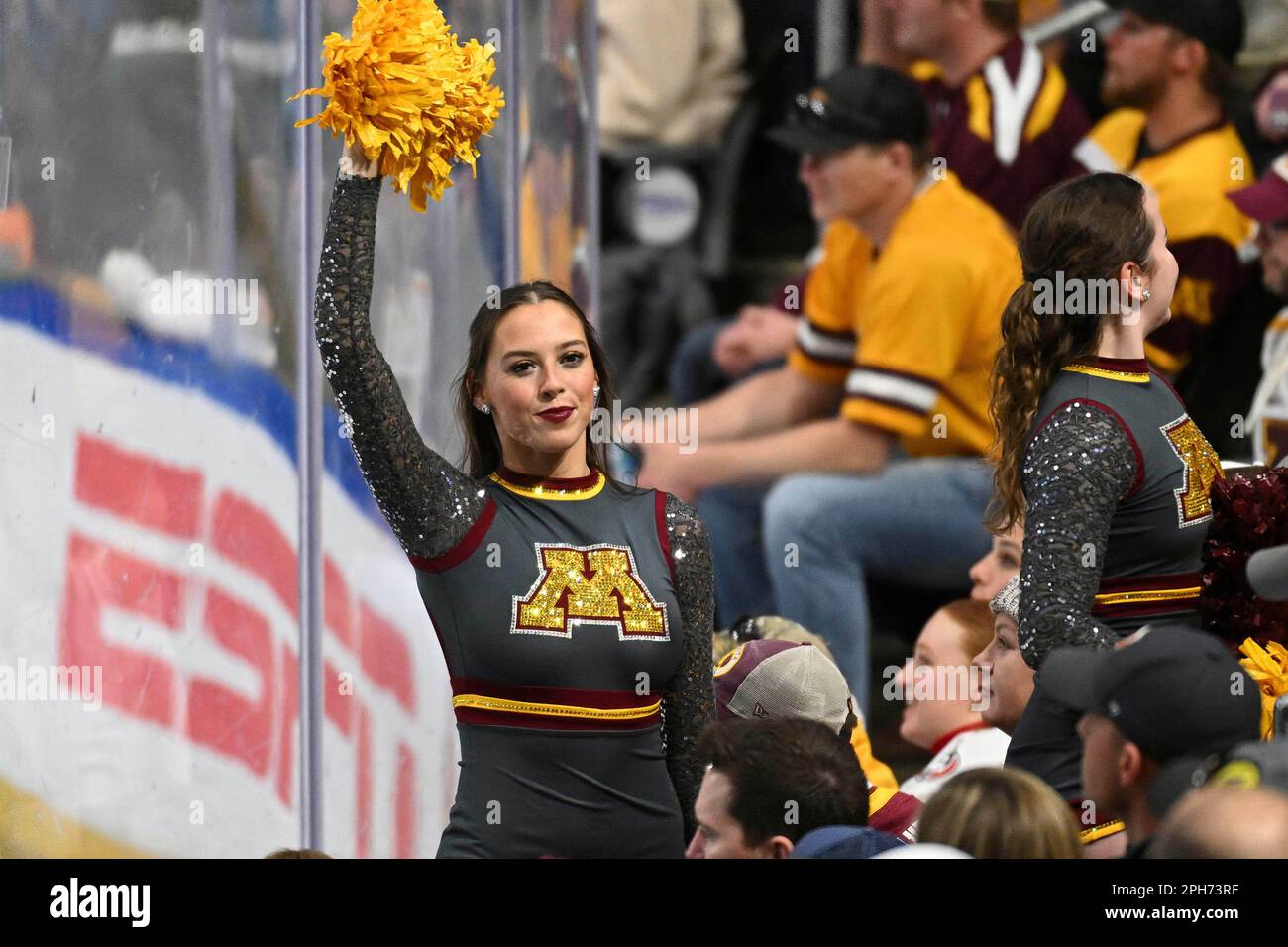 A Minnesota cheerleader performs in the crowd during the championship ...