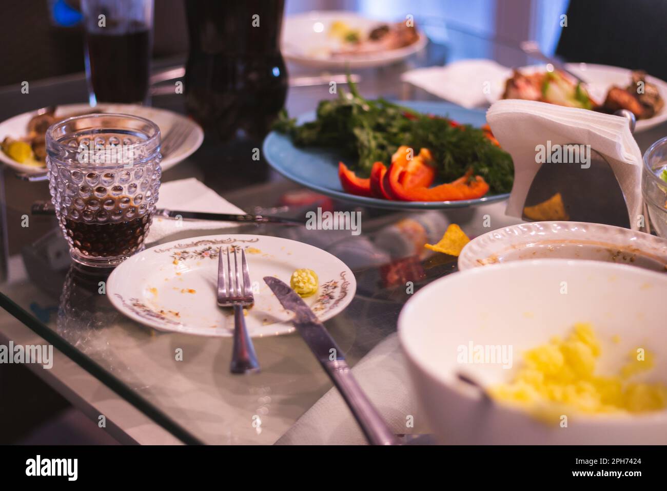 Dinner table after party. Empty plate after dinner. Dinner set for home ...