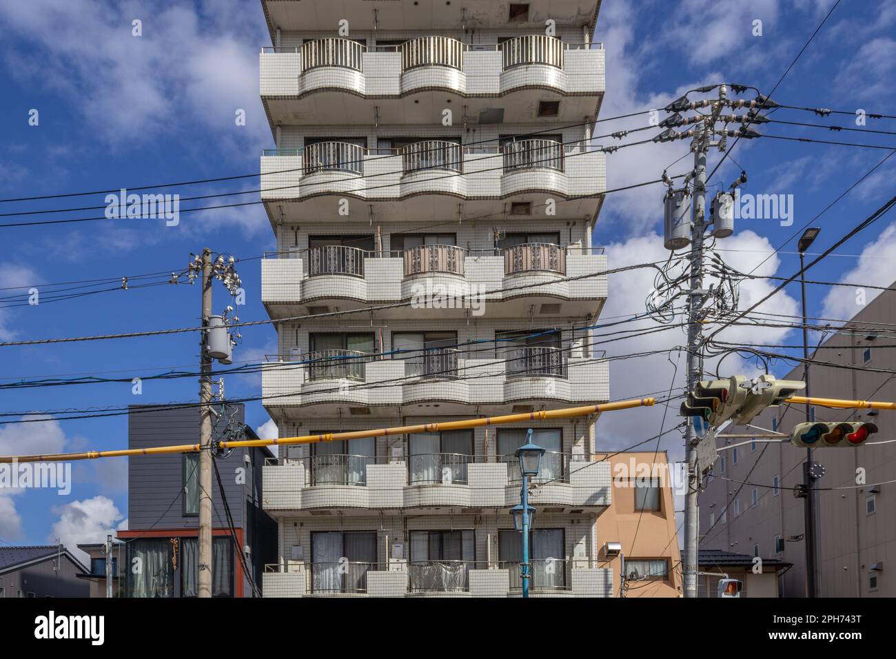 Apartment block with power and phone cables in foreground, in downtown ...