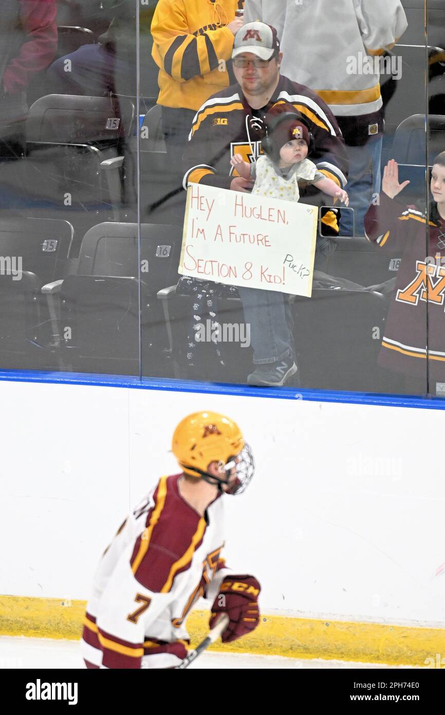 Fargo, USA. 25th Mar, 2023. Tyler Hagl and son Raylan hold up a sign ...