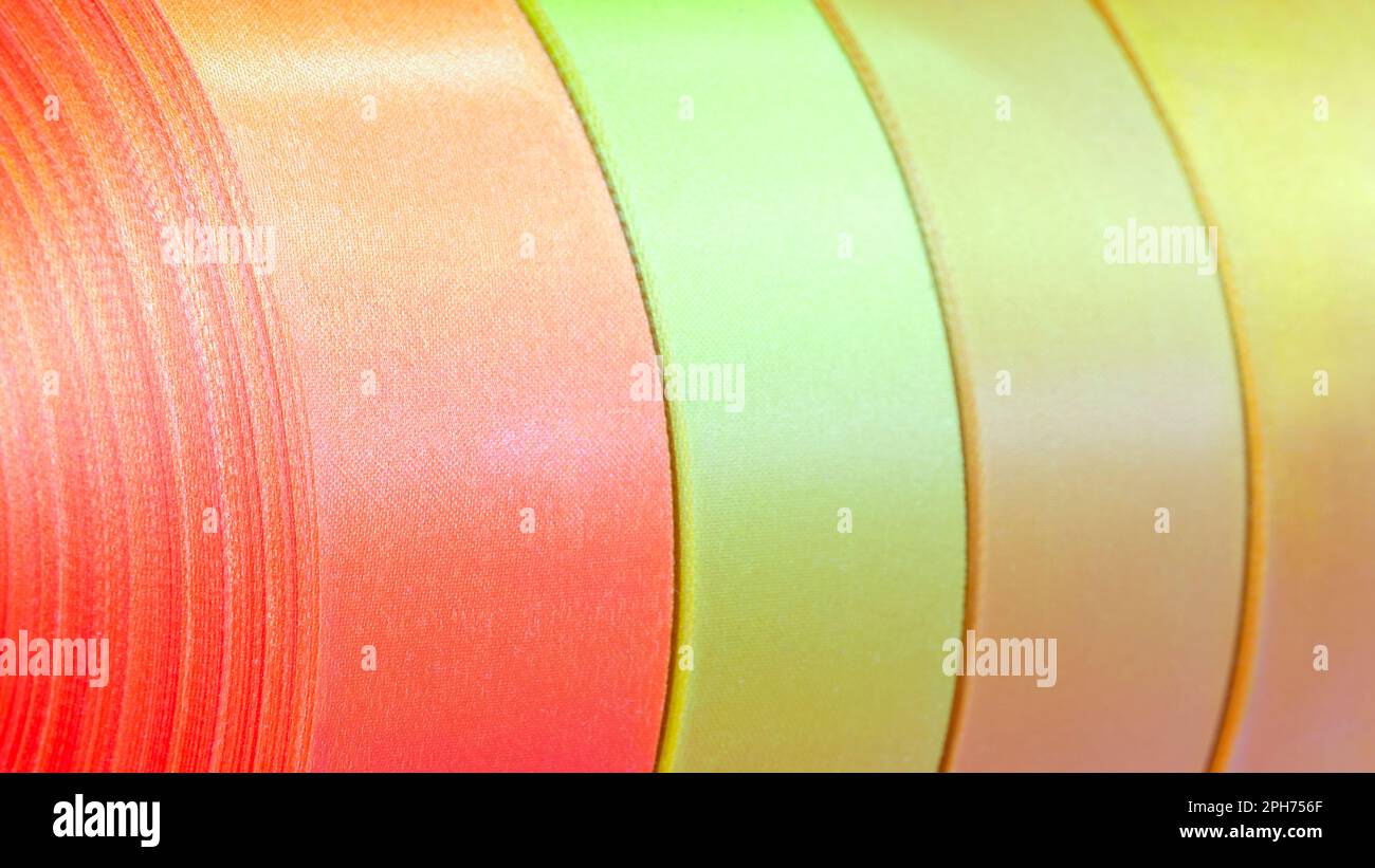 a set of a number of coils of satin ribbons in different colors for the ...