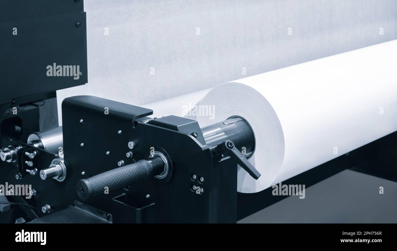 Rolls paper and fabric in wide industrial plotter Stock Photo - Alamy