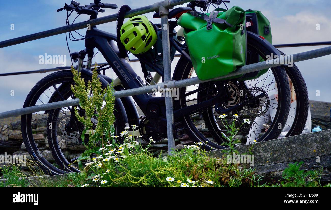 Two bicycles locked together and fixed to the railings with cycle gear ...