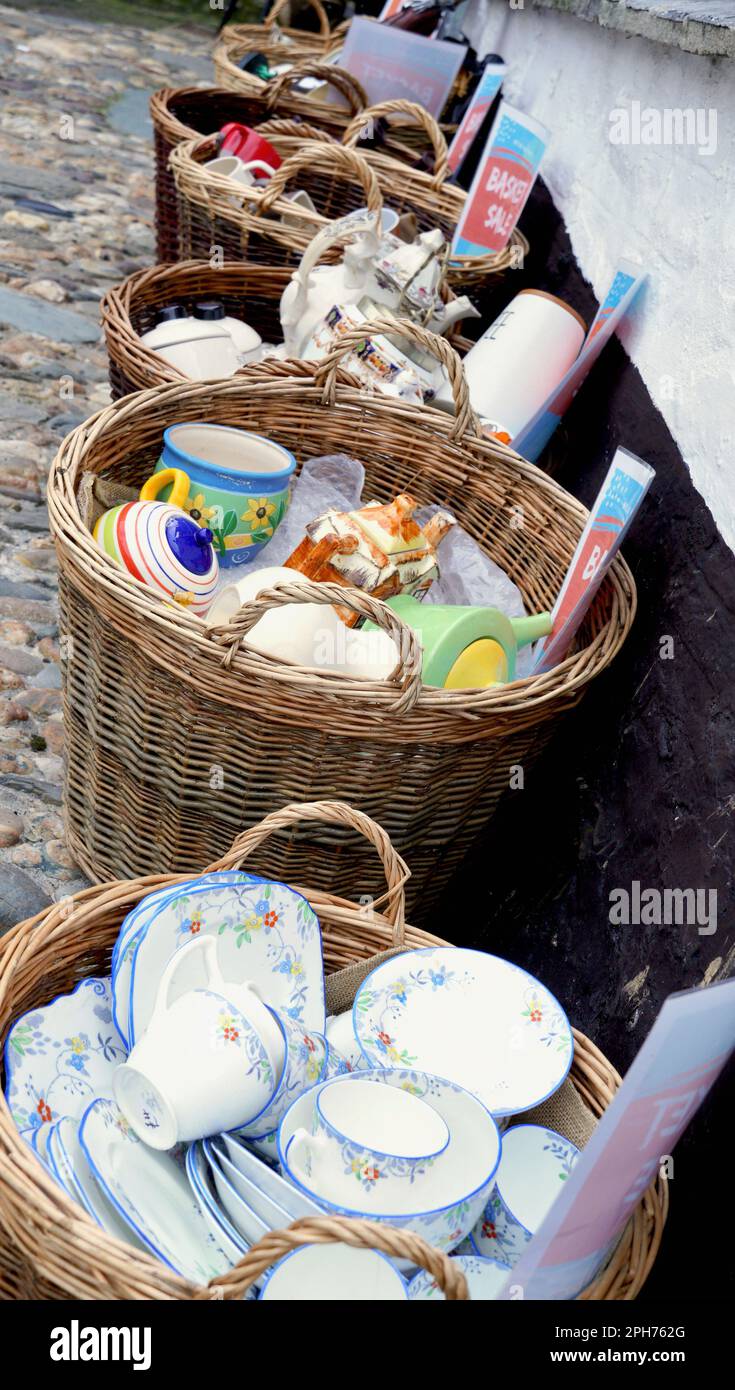 Baskets of vintage crockery ands china outside an antique shop in ...
