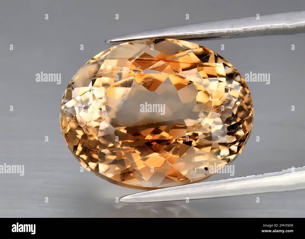 Natural gem orange topaz imperial on a gray background Stock Photo - Alamy