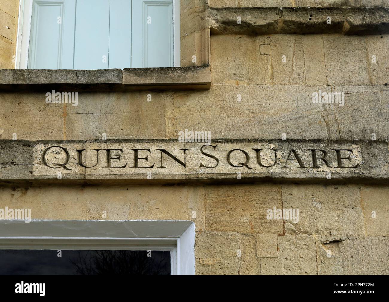 Carved sign for Queen Square street name, Bath, England on the side of ...